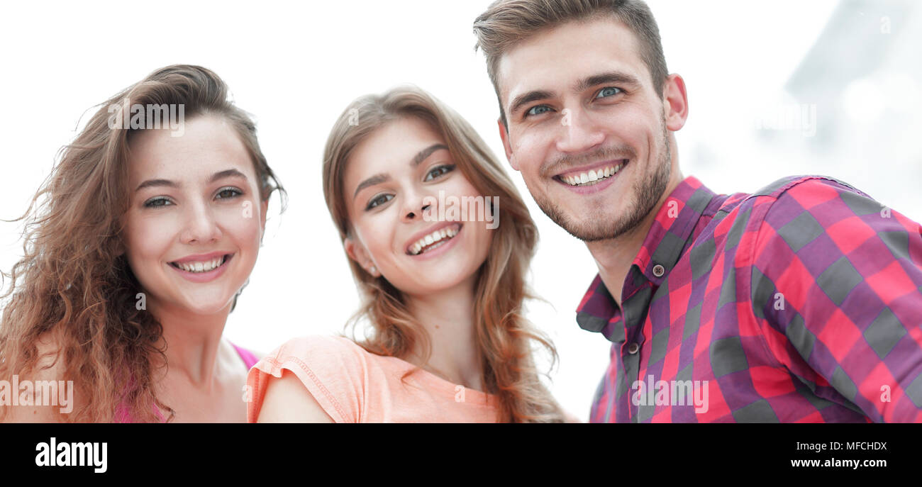 closeup of three young people smiling on white background Stock Photo ...