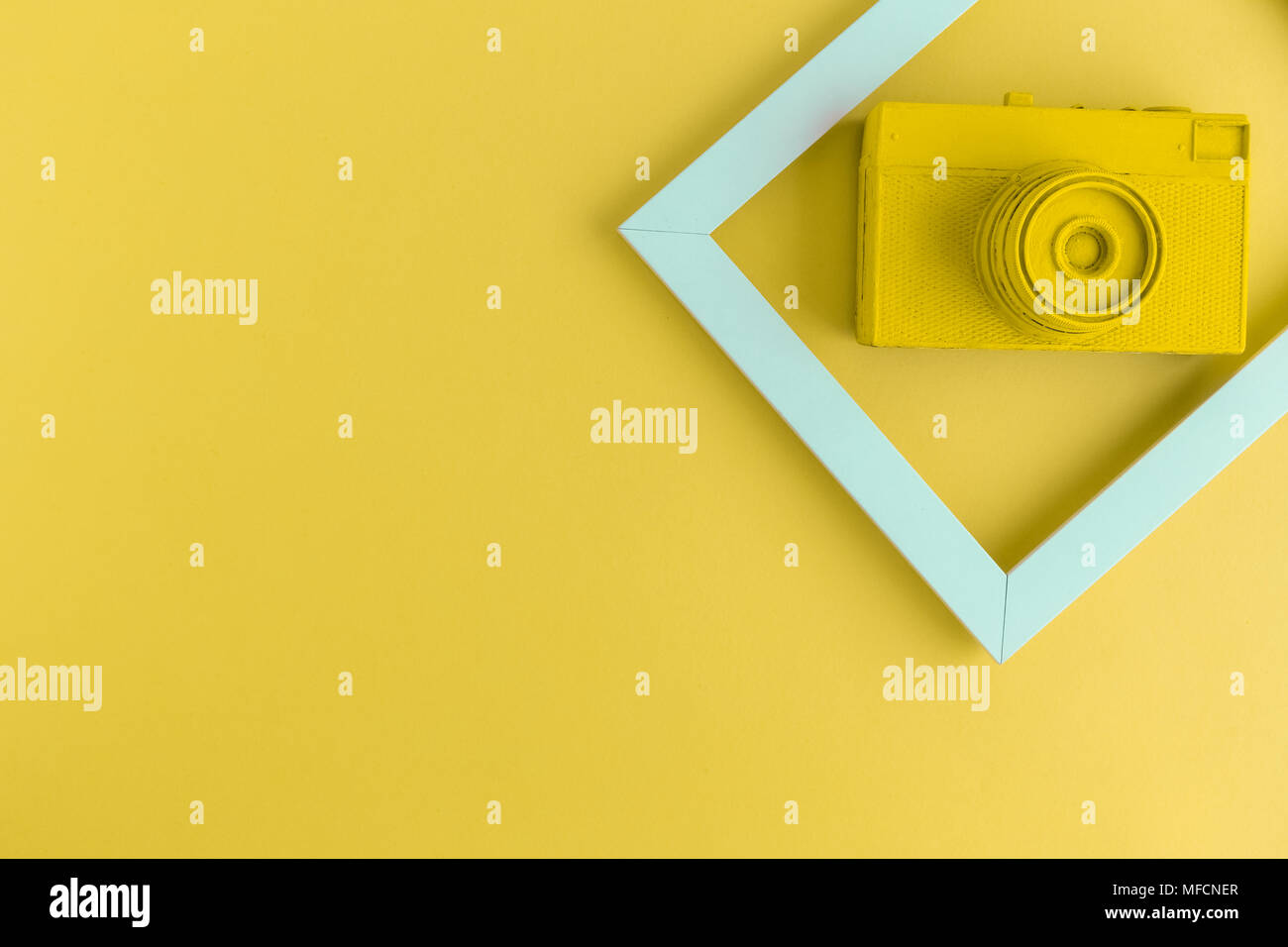 Retro film photo camera colored in yellow with photo frame minimal ...