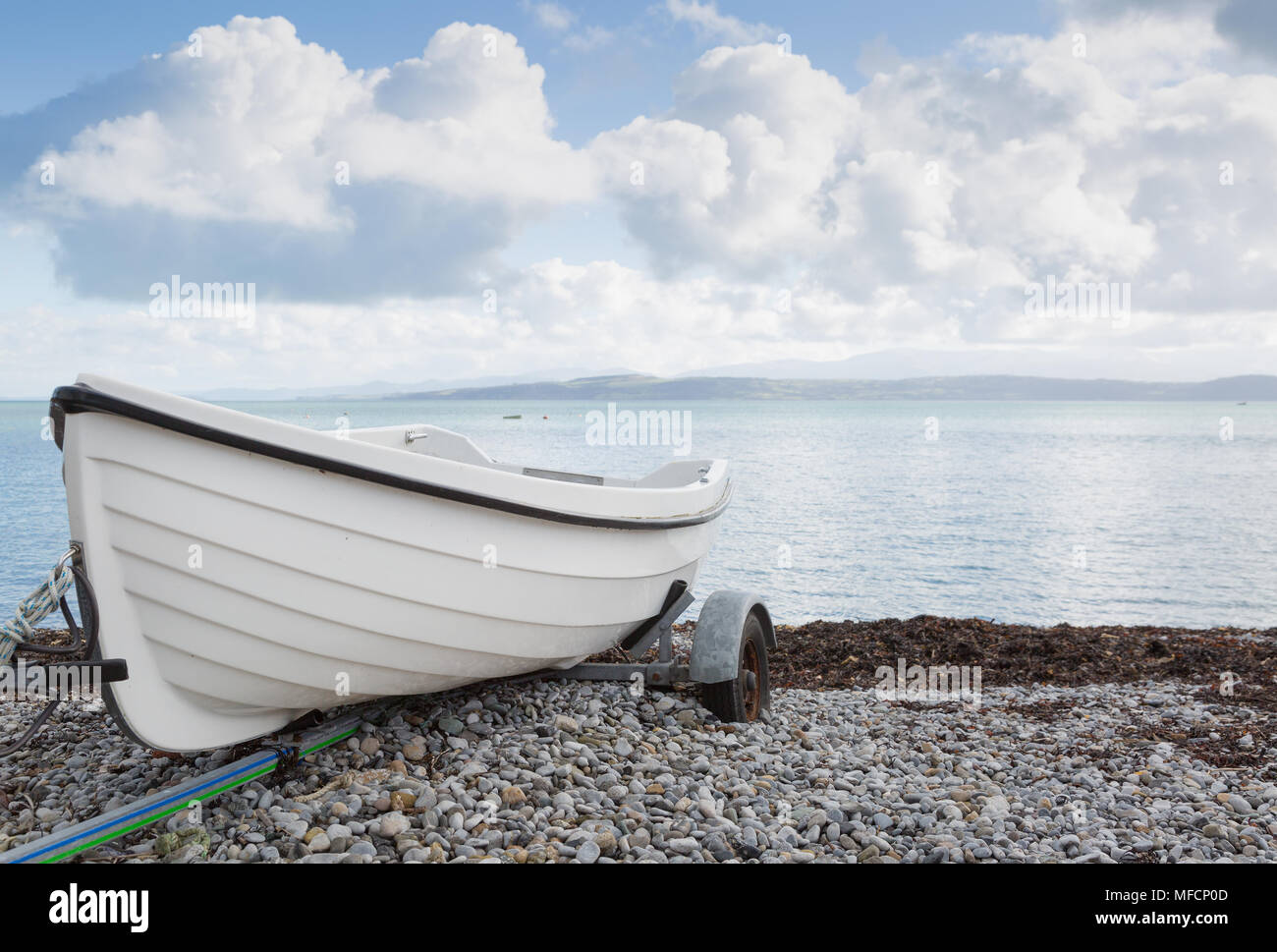 Small white dinghy on a trailer close to the sea Stock Photo - Alamy