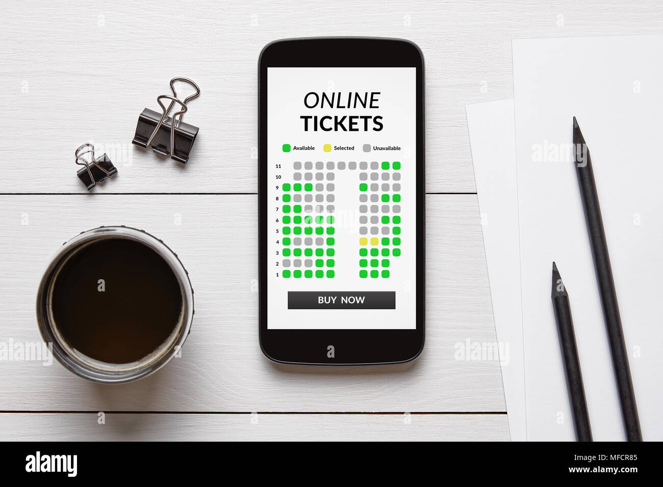 Online tickets concept on smart phone screen with office objects on ...