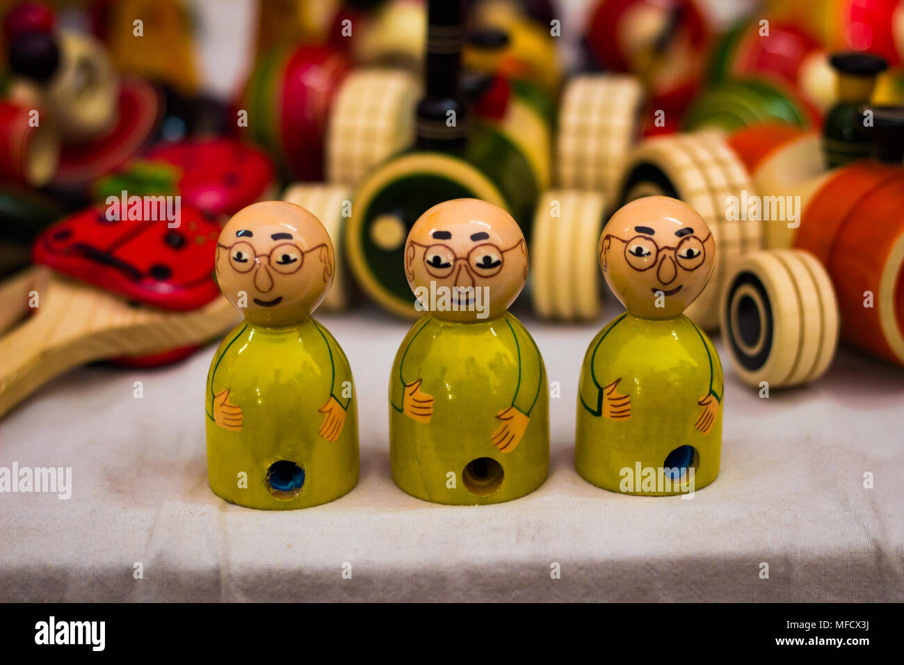 wooden three yellow dressed bald doll with spectacles. Gandhi model ...