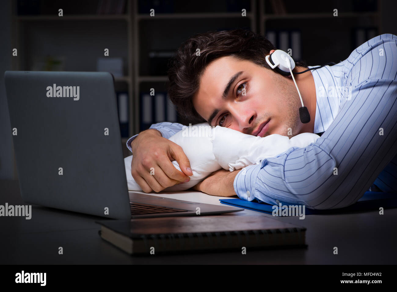 Tired and exhausted helpdesk operator during night shift Stock Photo ...