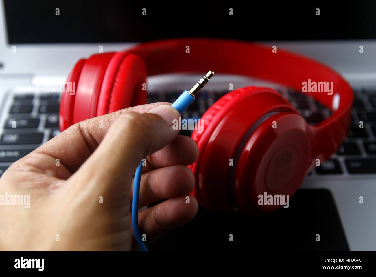 Photo of cable of stereo headphones and a laptop computer Stock Photo ...
