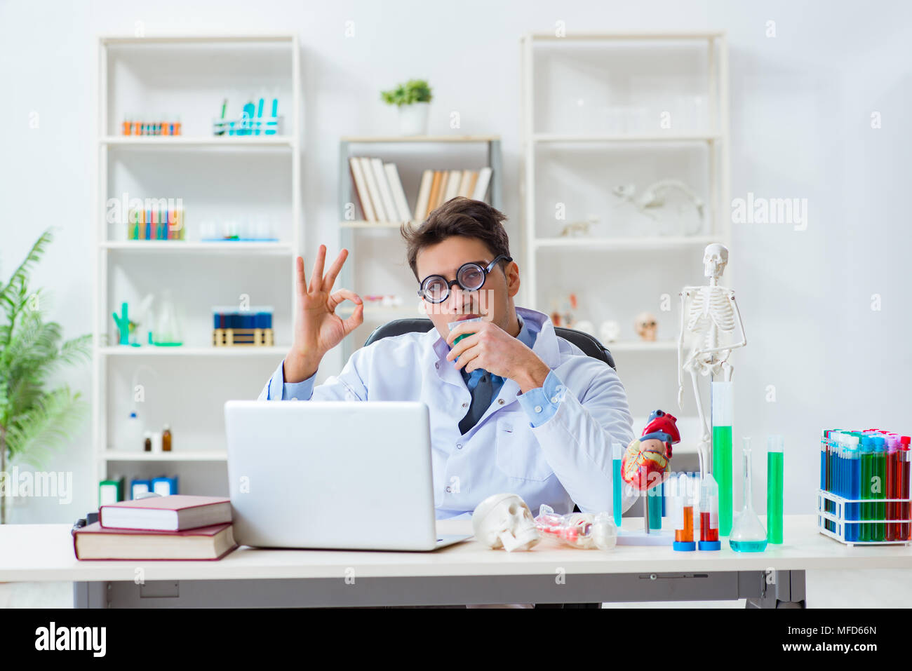 Funny doctor having fun in hospital lab Stock Photo - Alamy