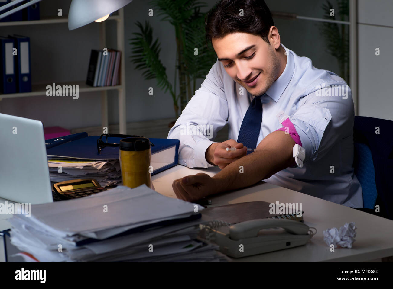 Employee relieving stress from overtime with drugs narcotics Stock ...