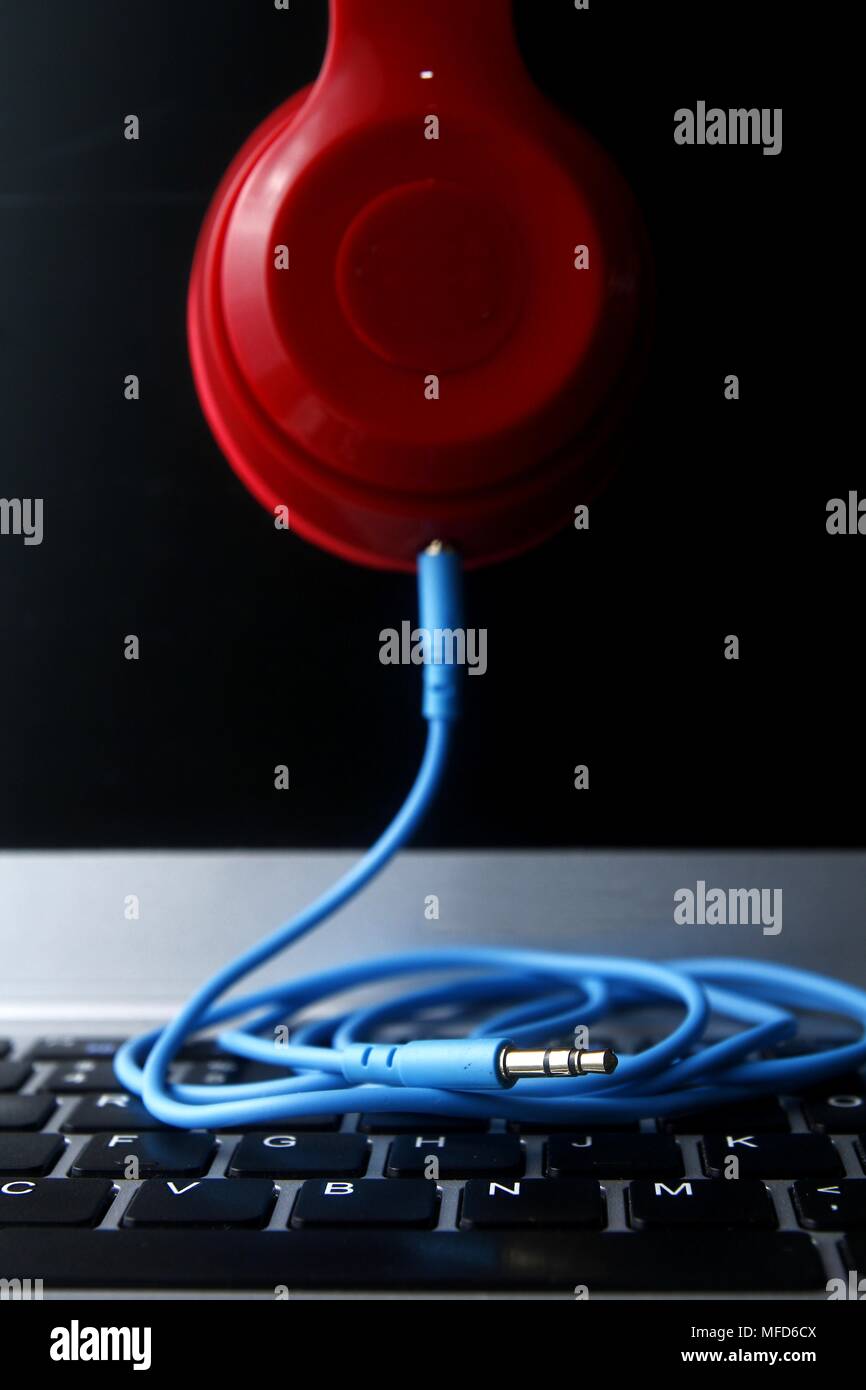 Photo of cable of stereo headphones and a laptop computer Stock Photo ...