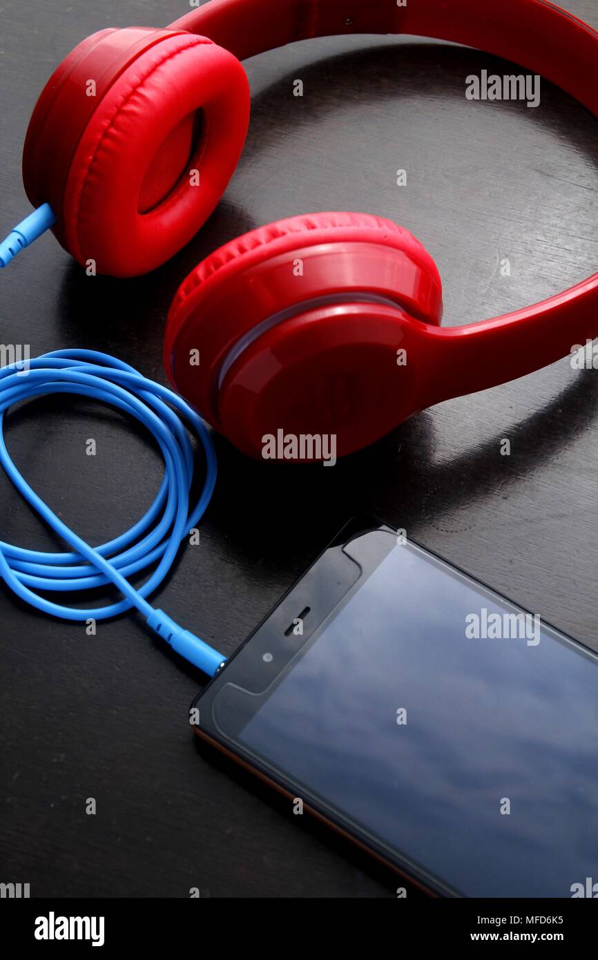 Photo of a smartphone and stereo headphones Stock Photo - Alamy