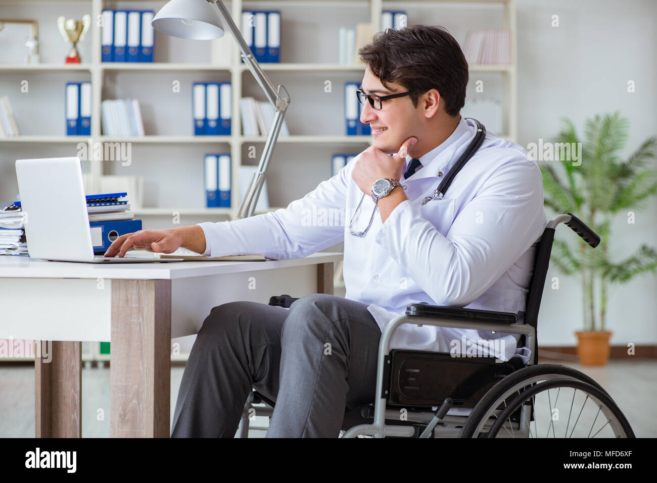 Disabled doctor on wheelchair working in hospital Stock Photo - Alamy