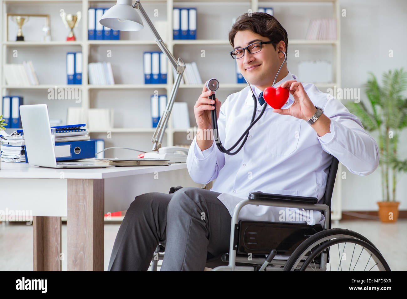 Disabled doctor on wheelchair working in hospital Stock Photo - Alamy