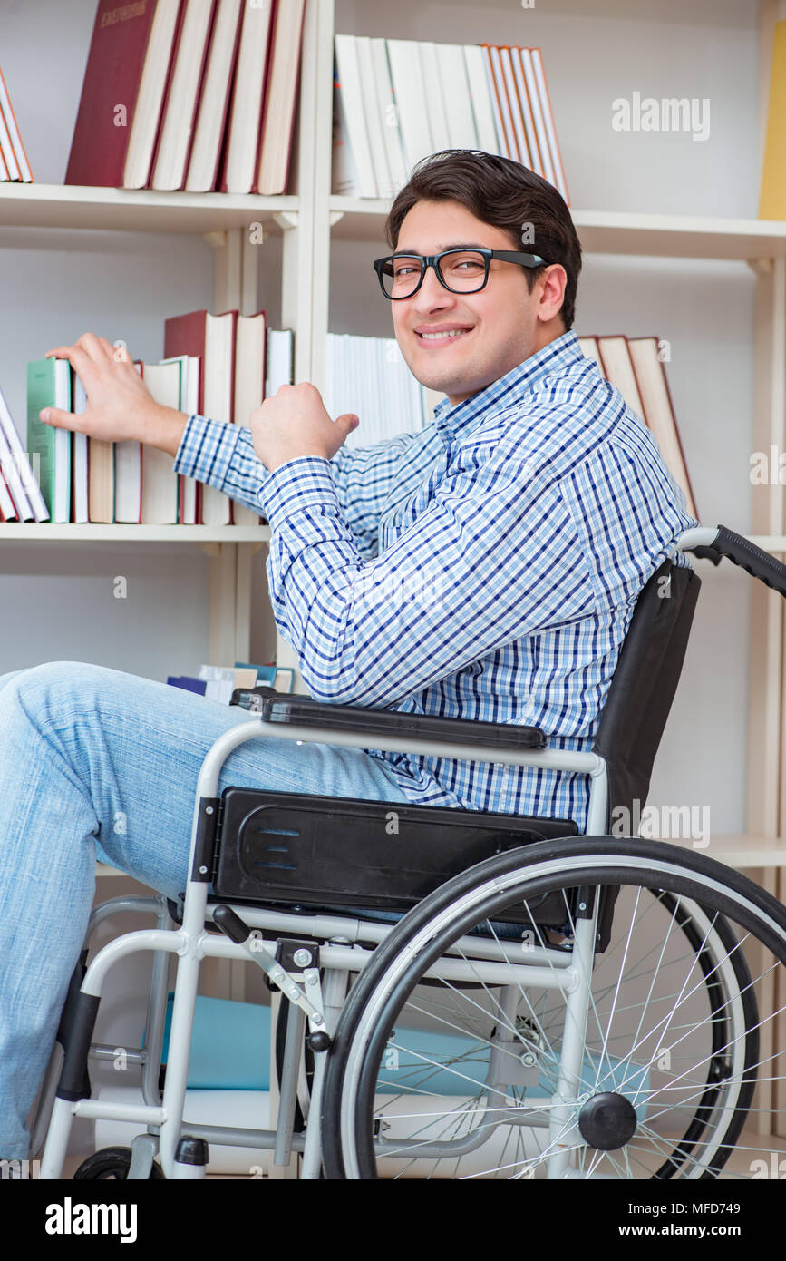 Disabled student studying in the library Stock Photo - Alamy