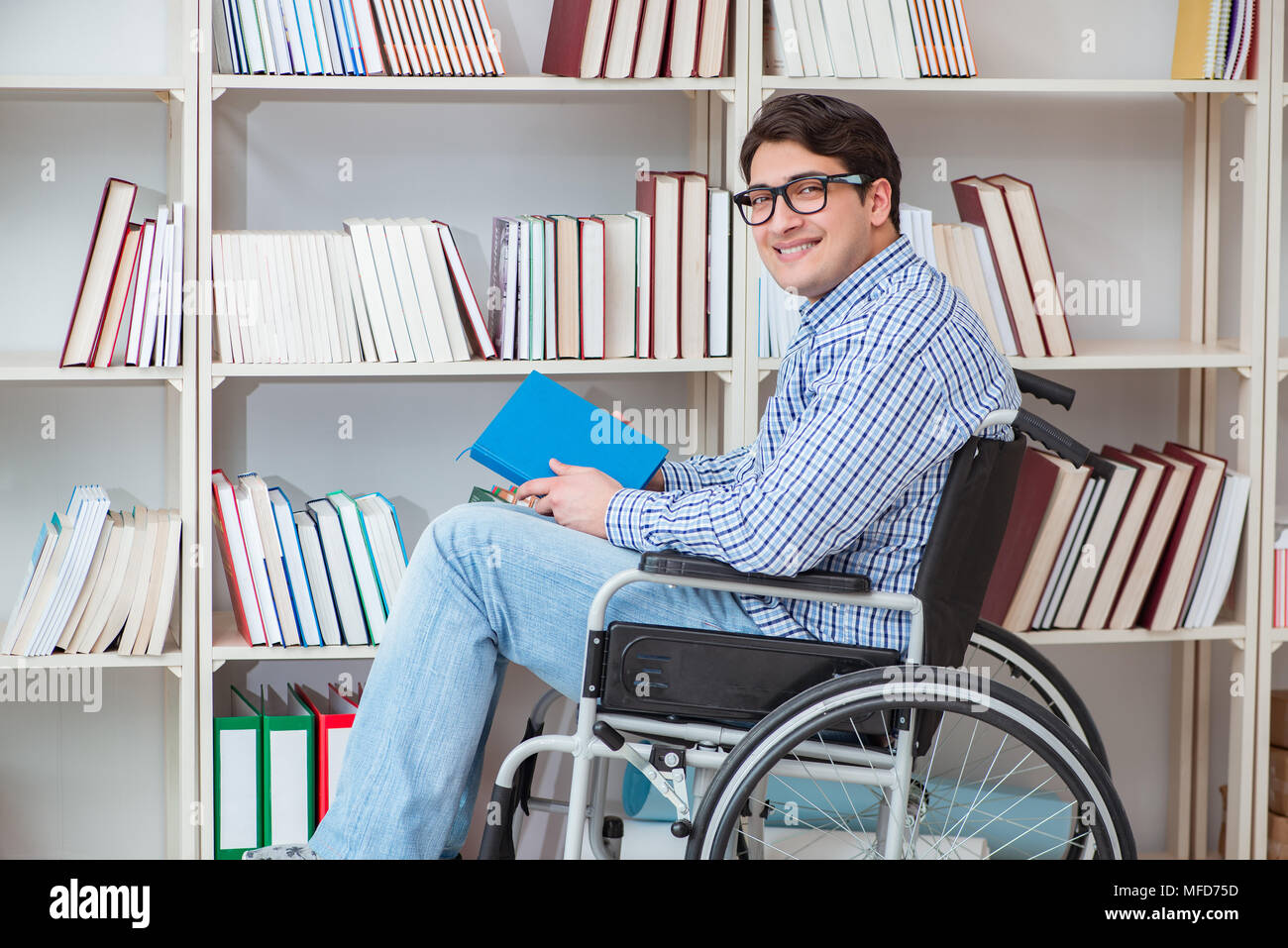 Disabled student studying in the library Stock Photo - Alamy