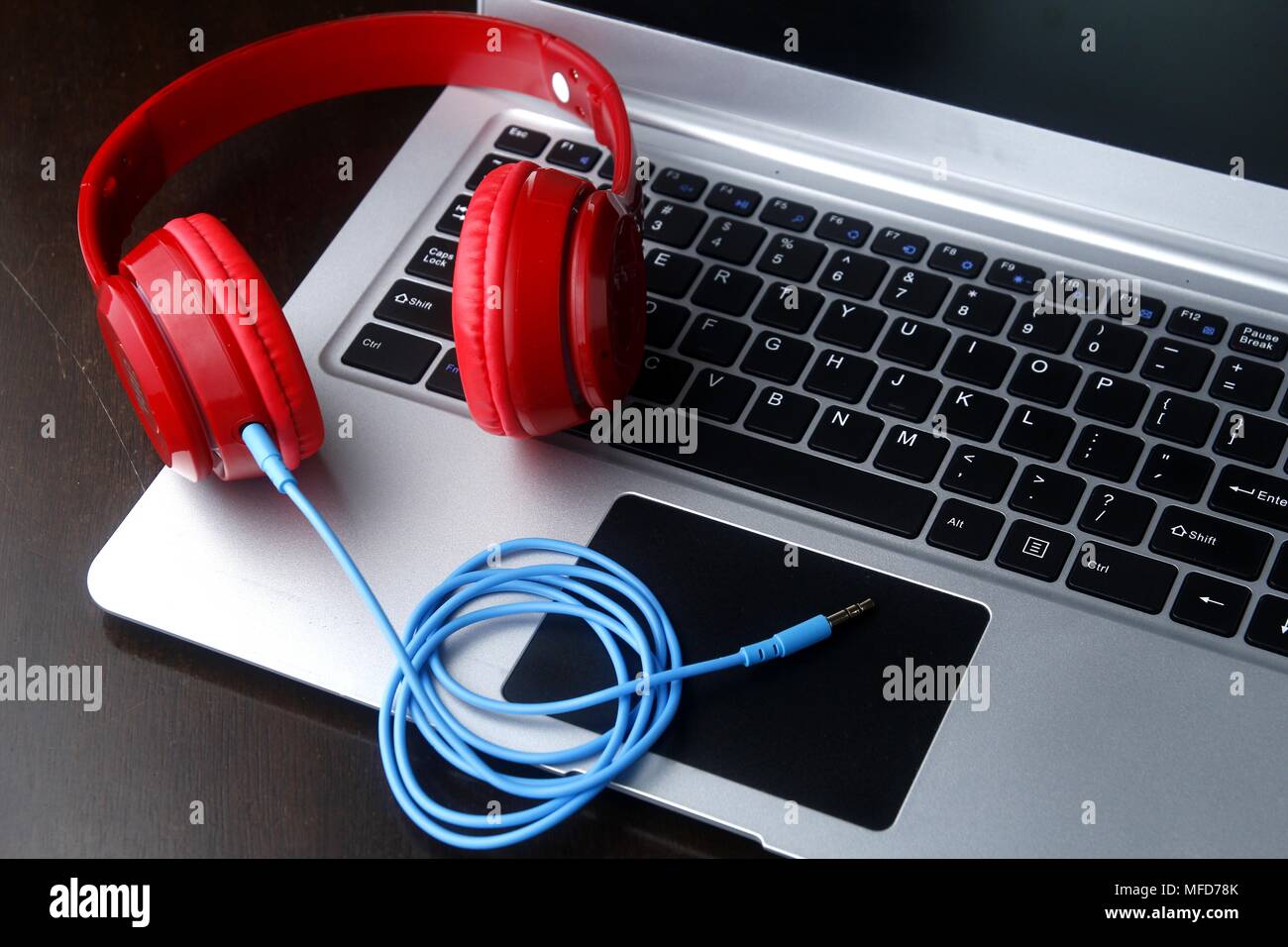 Photo of stereo headphones and a laptop computer Stock Photo - Alamy