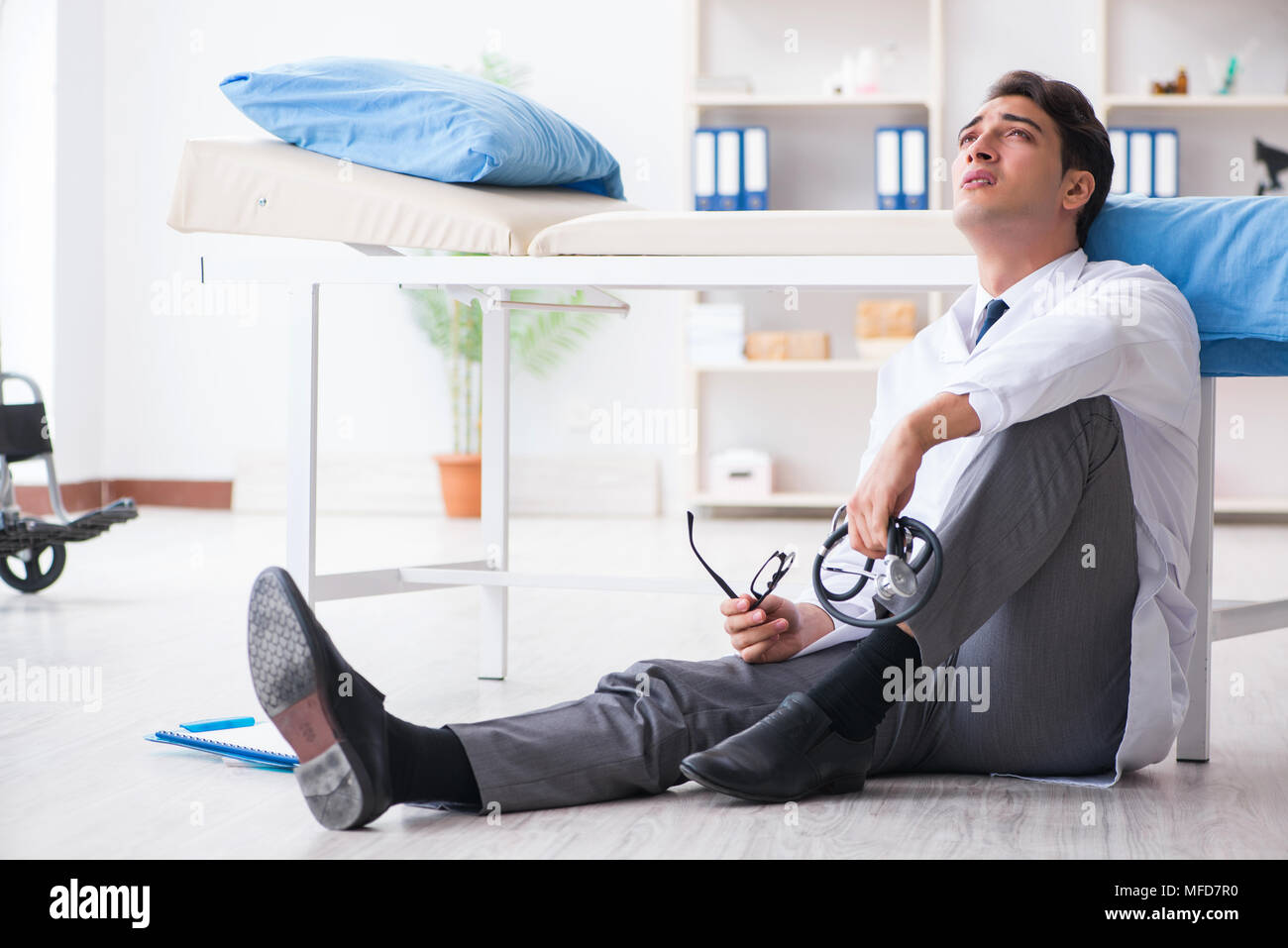 Doctor sitting on the floor in hospital Stock Photo - Alamy