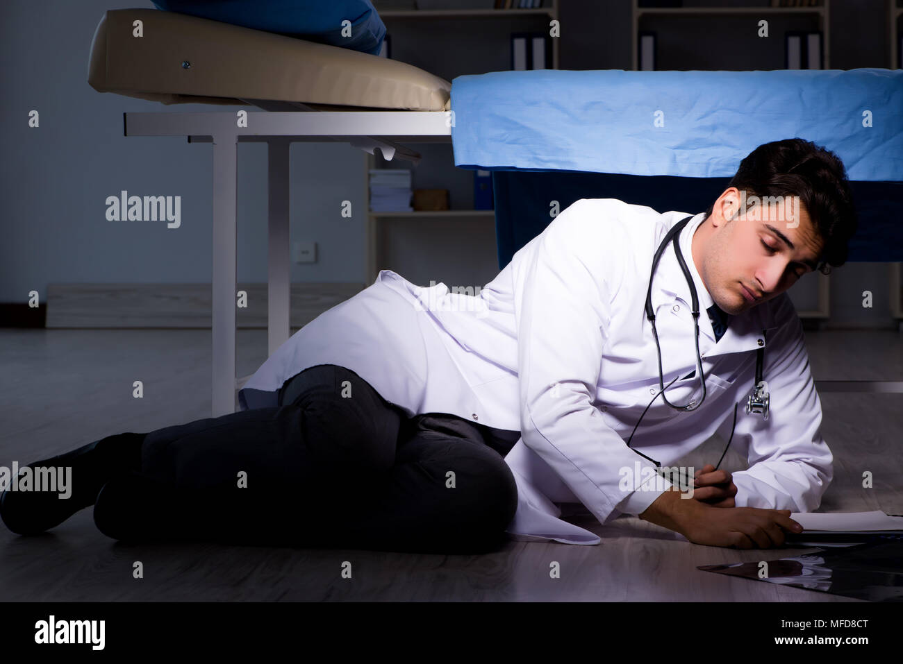 Doctor working night shift in hospital after long hours Stock Photo - Alamy