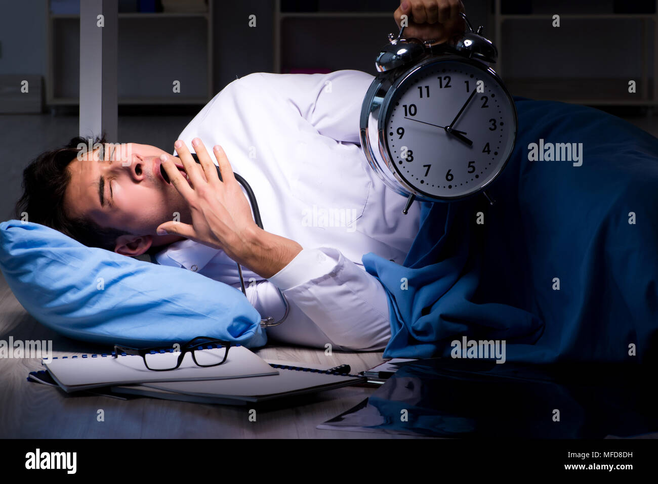 Doctor working night shift in hospital after long hours Stock Photo - Alamy