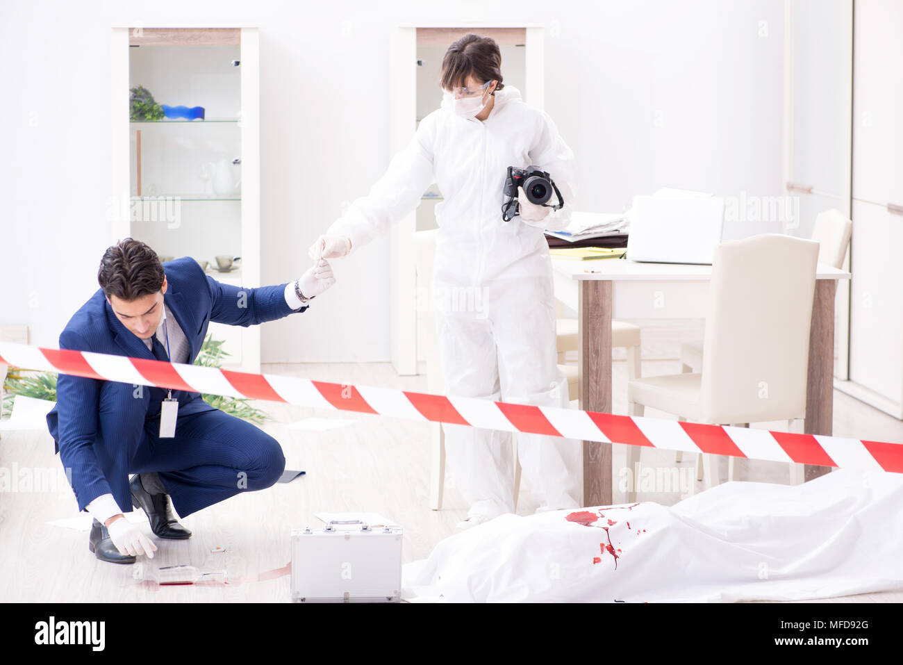 Forensics investigator at the scene of office crime Stock Photo - Alamy
