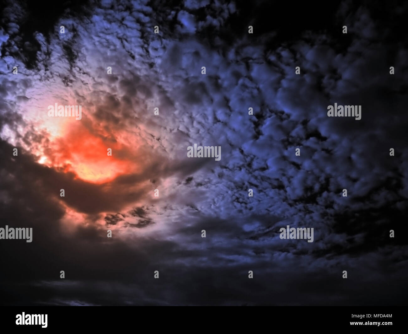 Red Sun Dawn behind Clouds Stock Photo - Alamy