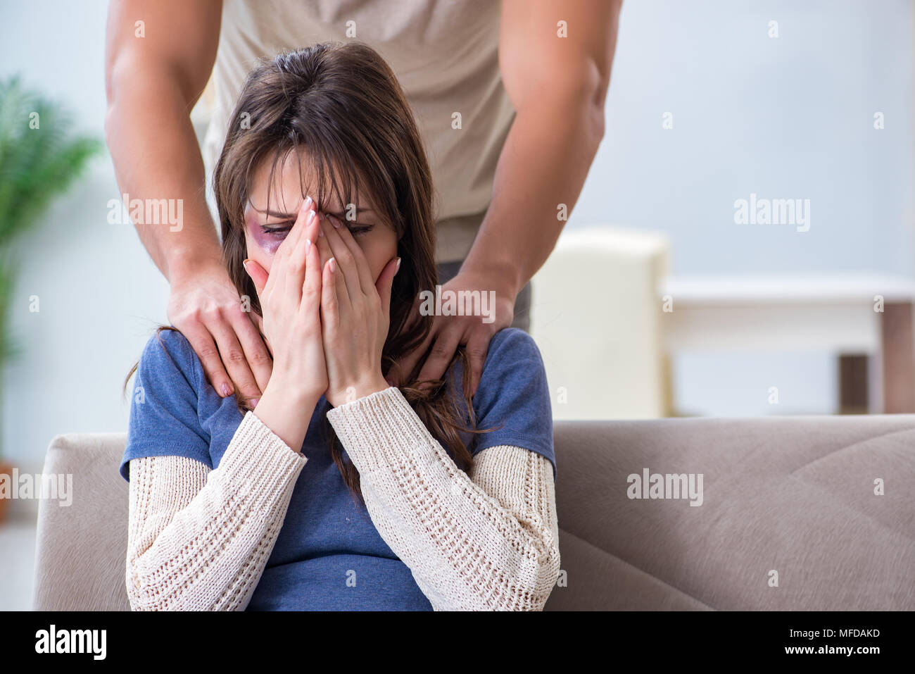 Desparate wife with aggressive husband in domestic violence concept ...