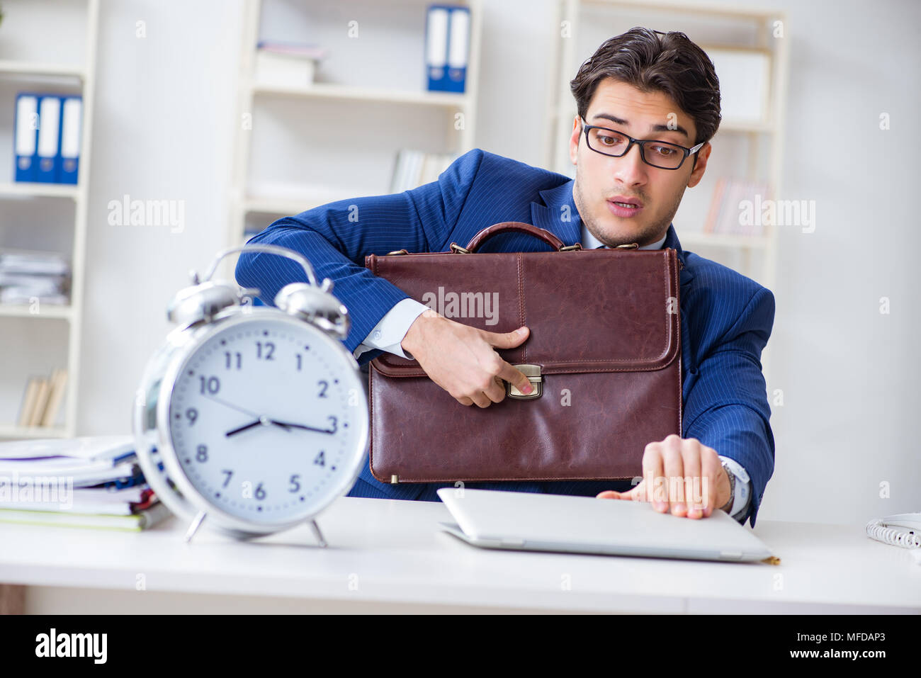 Businessman in bad time management concept Stock Photo - Alamy