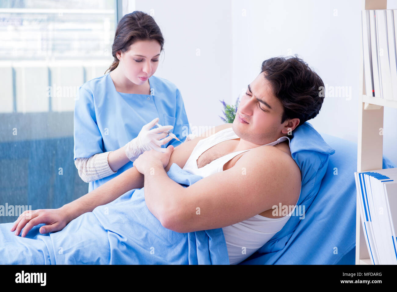 Doctor doing medical injection in hospital room Stock Photo - Alamy