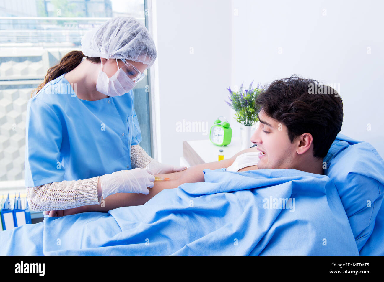 Doctor doing medical injection in hospital room Stock Photo - Alamy