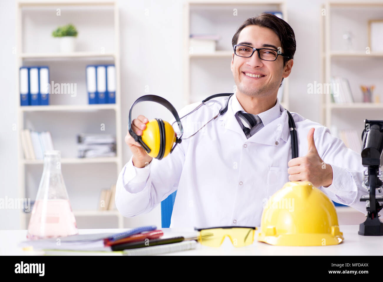 Safety doctor advising about noise cancelling headphones Stock Photo ...