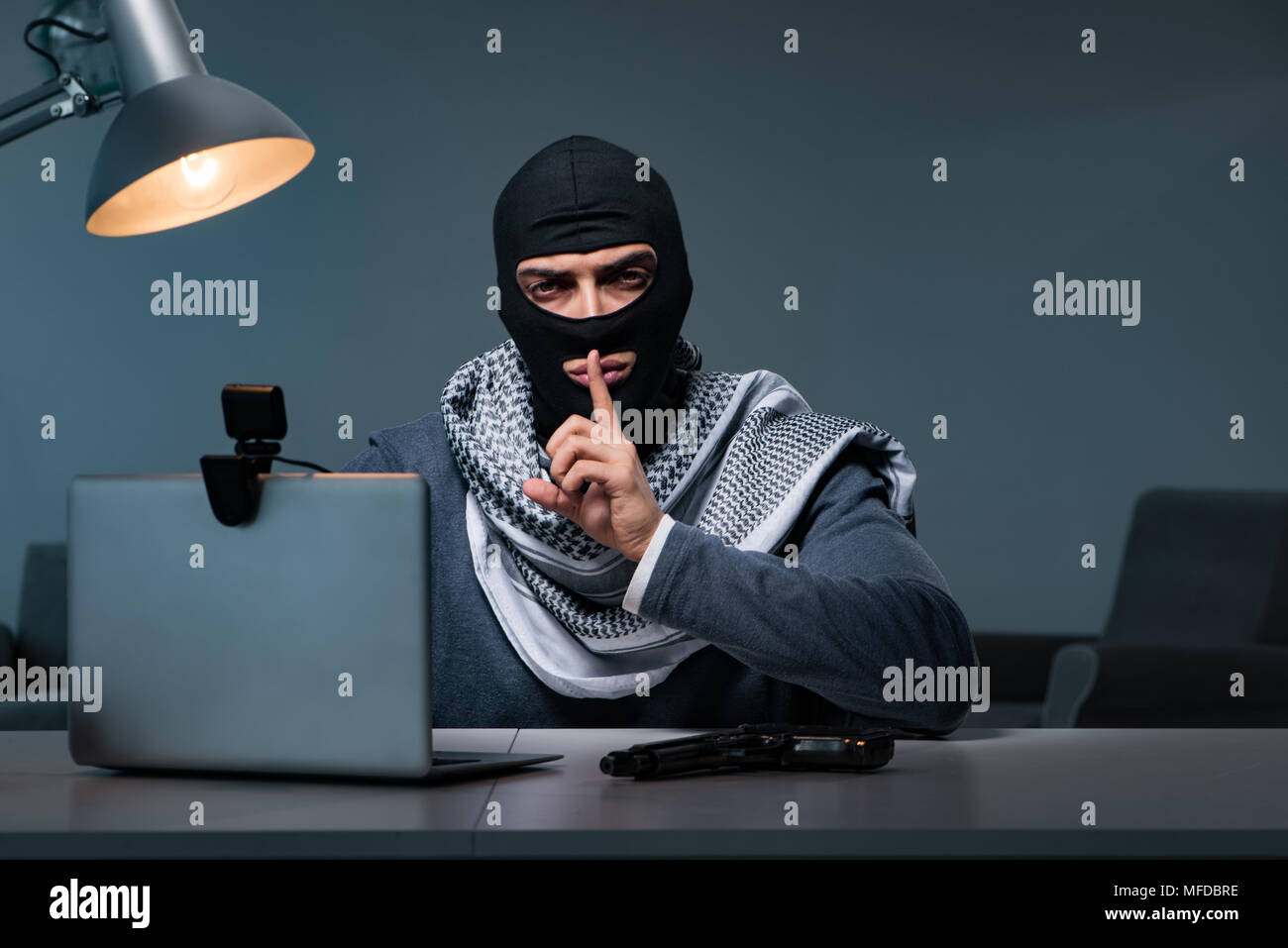 Hacker wearing balaclava mask hacking computer Stock Photo - Alamy