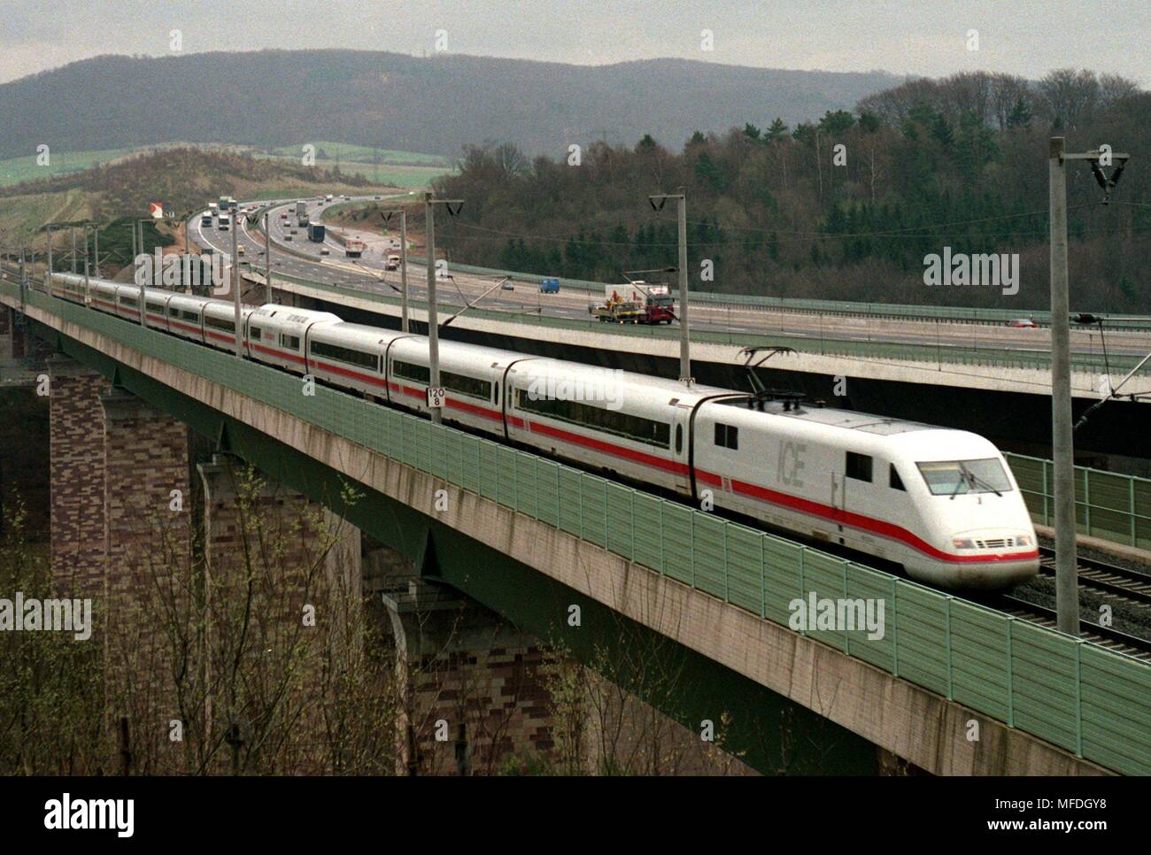 An ICE train goes next to the motorway Hannover - Kassel over the ...
