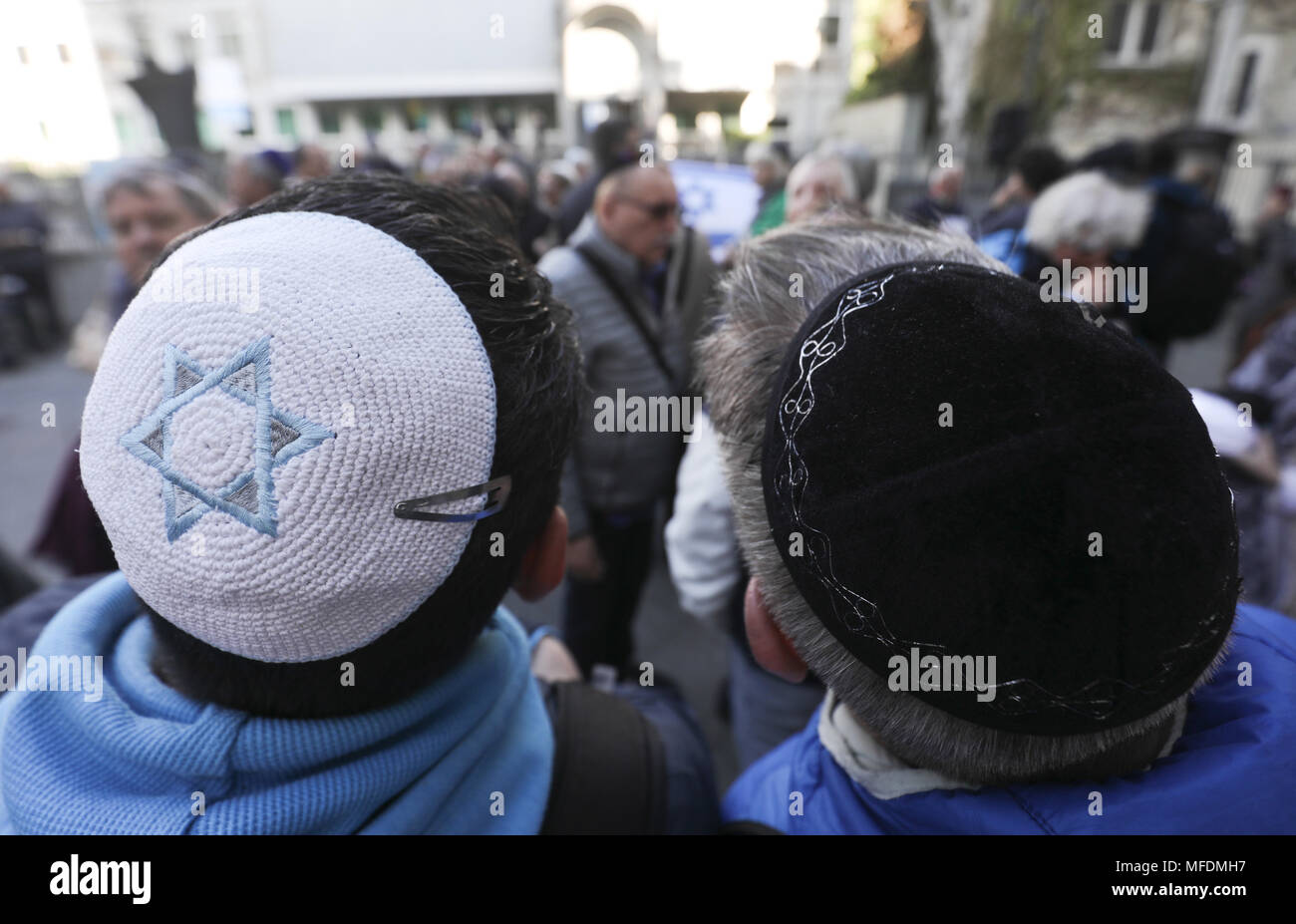 25 April 2018, Germany, Berlin: Two men wearing kippahs taking part in ...