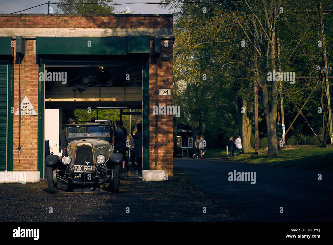 Vintage Car sits in doorway of red bricked garage Stock Photo - Alamy