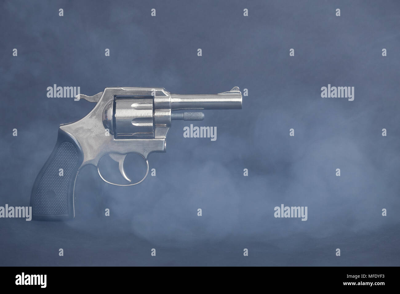 Pistol and smoke on dark background. Space for copy Stock Photo - Alamy