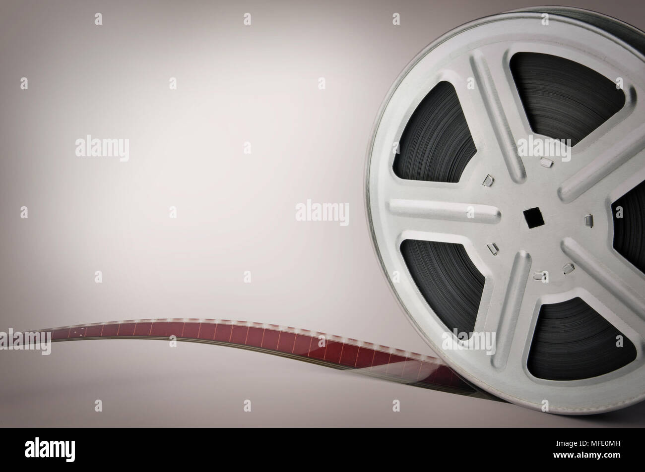 Old motion picture film reel on brown background Stock Photo - Alamy