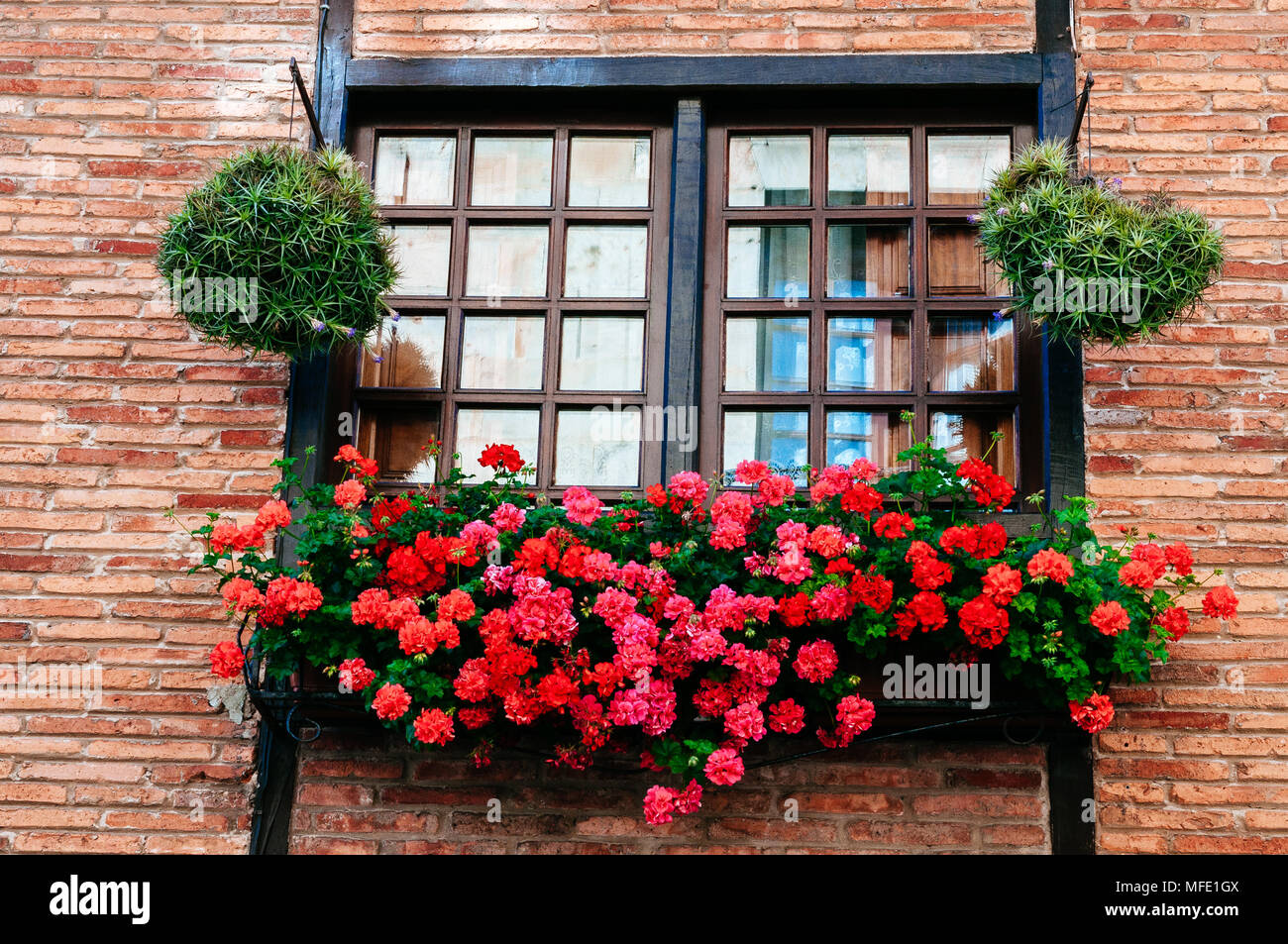 Colourful window in a traditional stone house Stock Photo - Alamy