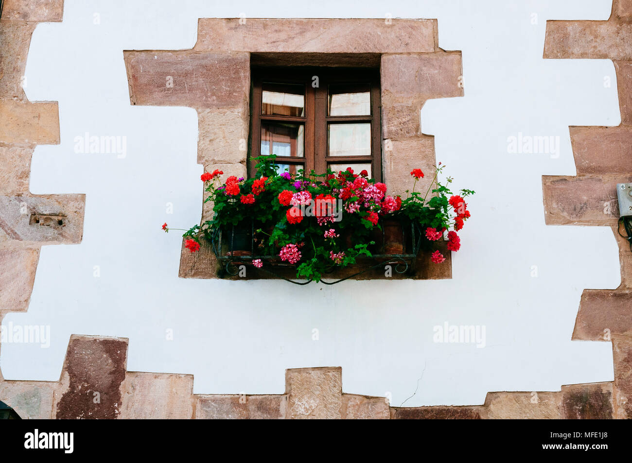 Colourful window in a traditional stone house Stock Photo - Alamy