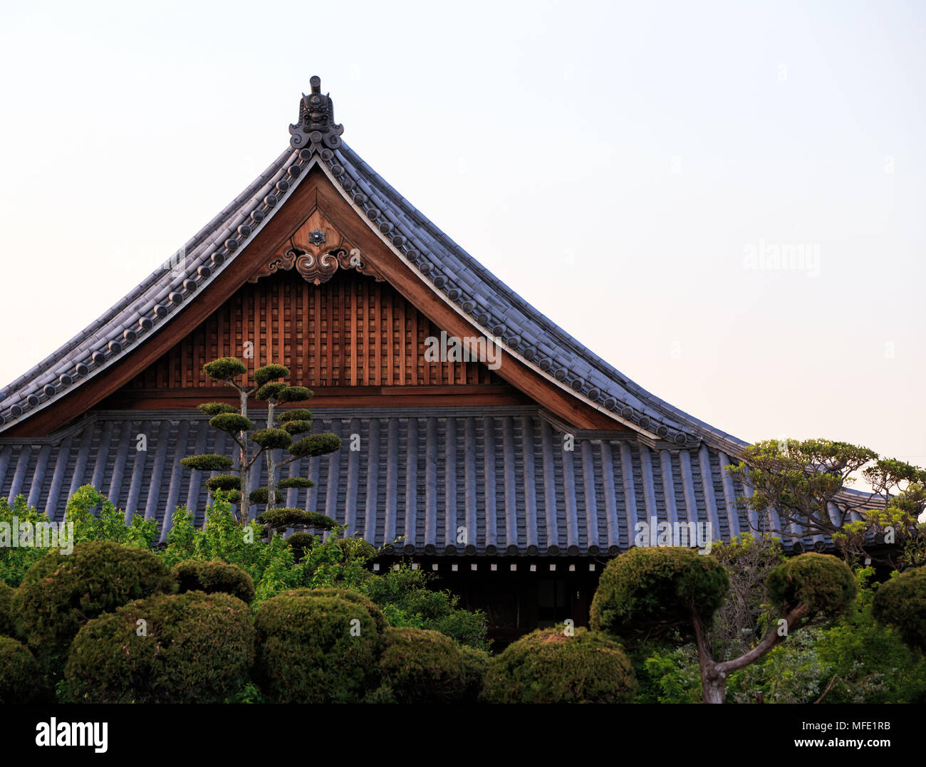 Small Japanese wooden temple with bright green summer trees Stock Photo ...