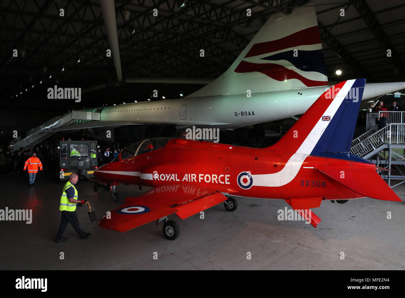 The Red Arrows Hawk is maneuvered into a hanger next to Concorde where ...