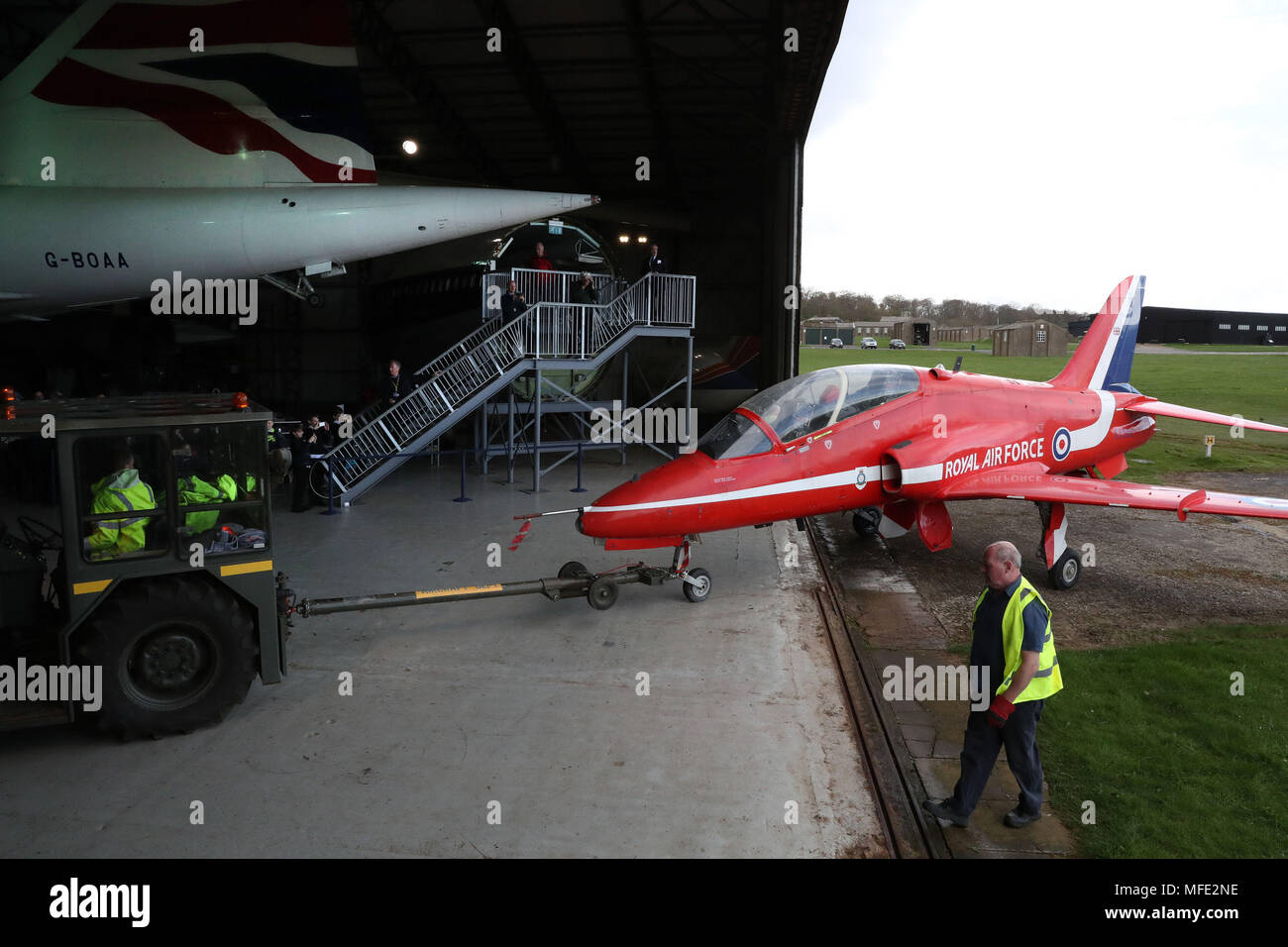 The Red Arrows Hawk is maneuvered into a hanger next to Concorde where ...