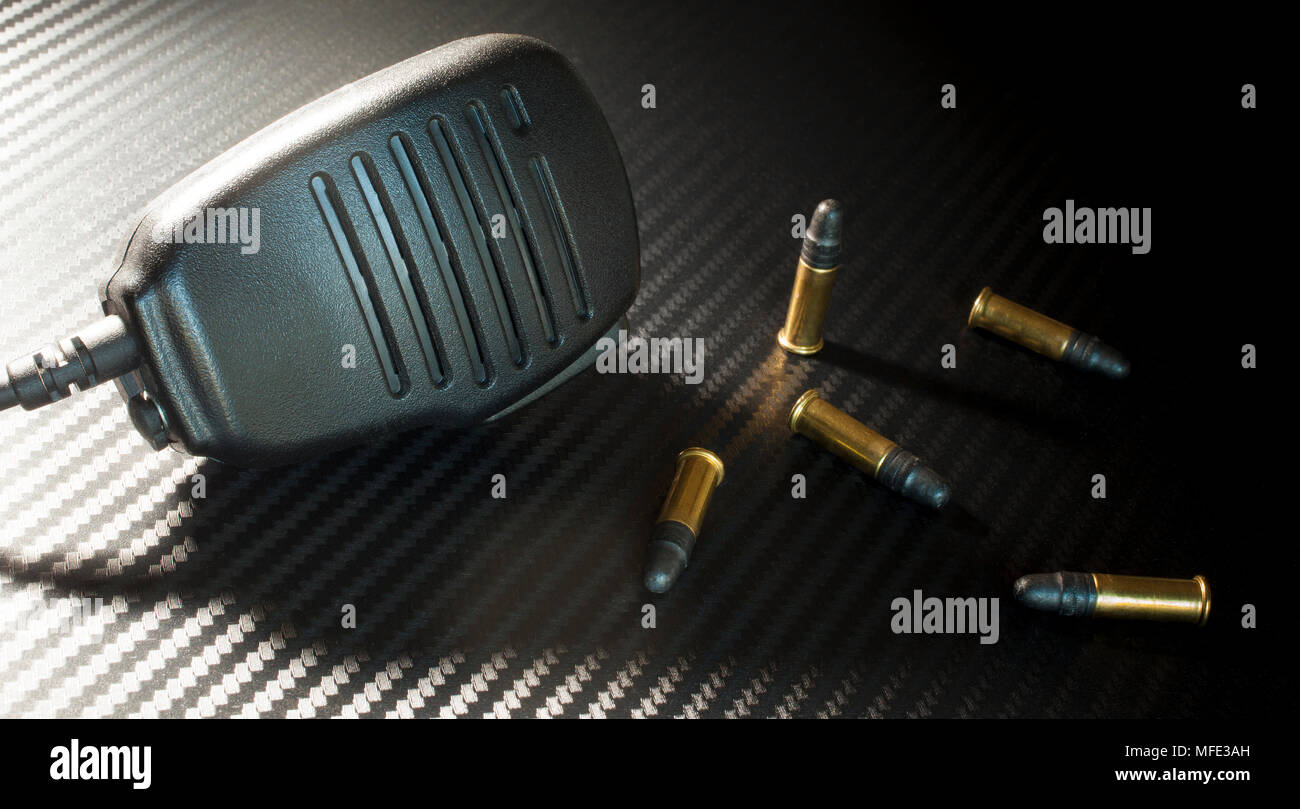 Five rim fire cartridges with a police style microphone Stock Photo - Alamy