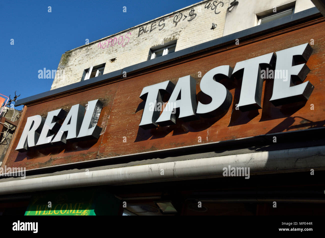 Real Taste sign above a fast food outlet Stock Photo - Alamy
