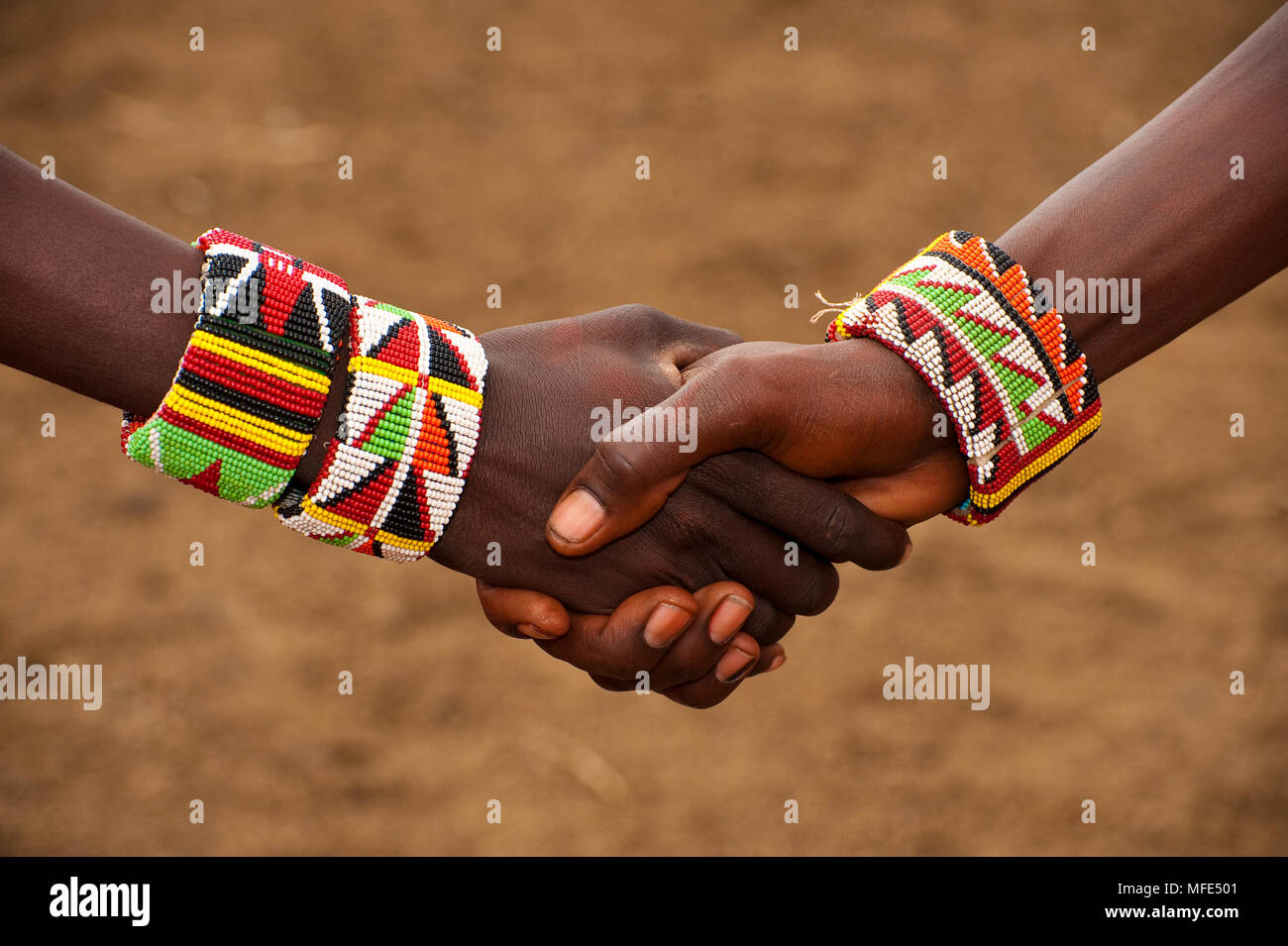 Two Masai morans ("warriors") shake hands; Masai Mara, Kenya Stock ...