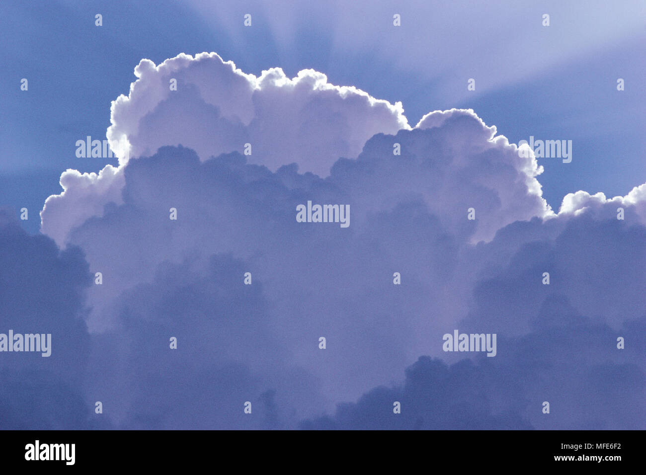 SHOWER CUMULUS CLOUD with rays emanating from sun behind cloud Stock ...