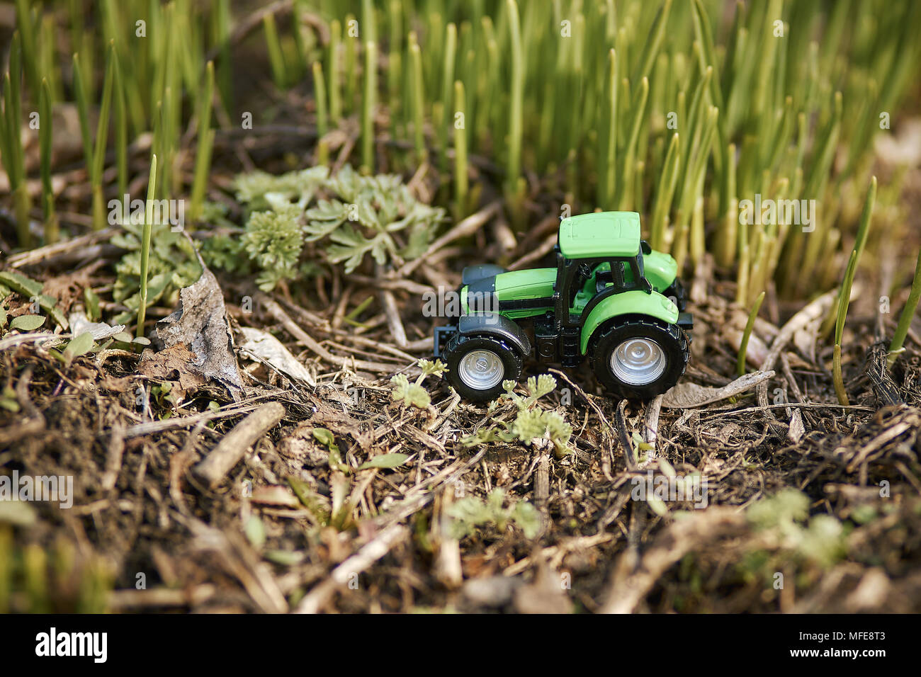 toy tractor on green grass background . Spring sowing works Stock Photo ...