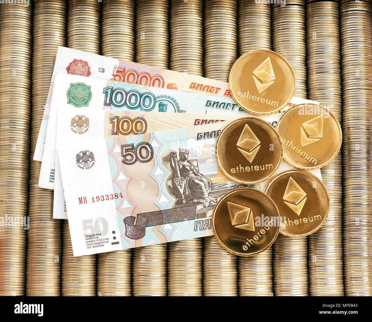 Gold crypto coins Ethereum ETH, paper of Russian rubles. Metal coins ...
