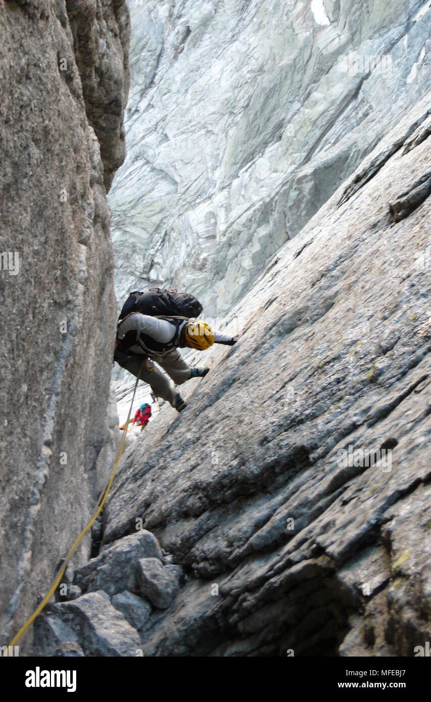mountain guide on a hard granite climb to a high alpine peak in the ...