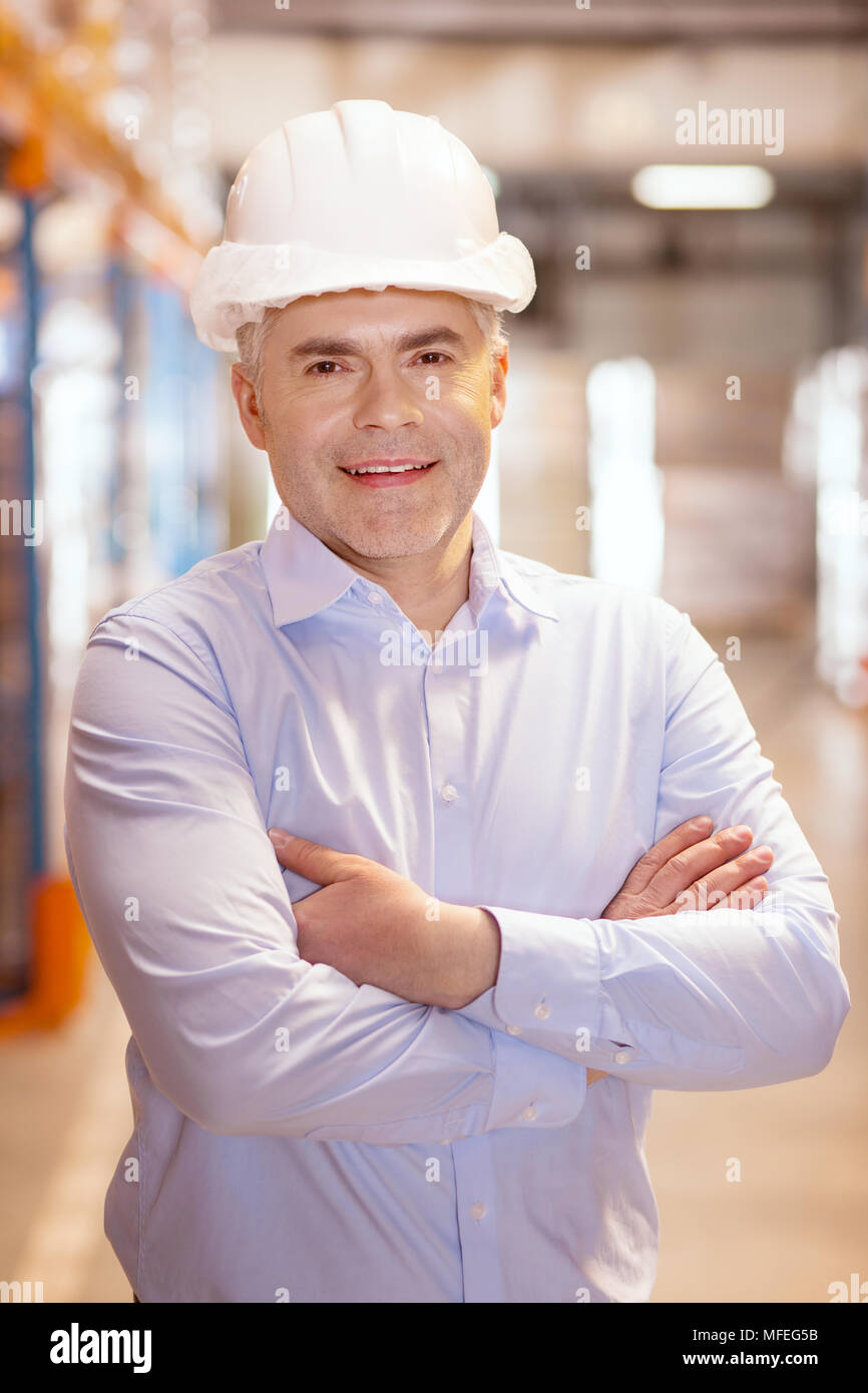 Positive warehouse worker smiling Stock Photo - Alamy
