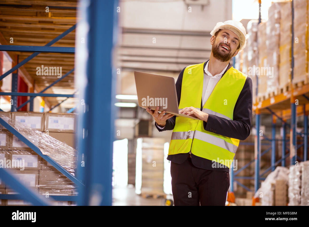Smart positive man observing the working process Stock Photo - Alamy