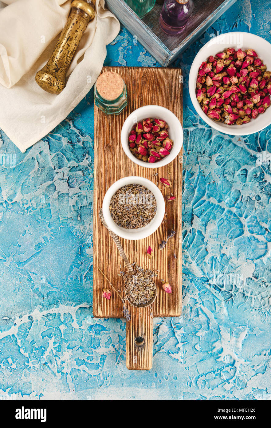 Assortment of dry medicinal herbs roses buds and lavender in bowls. Top ...