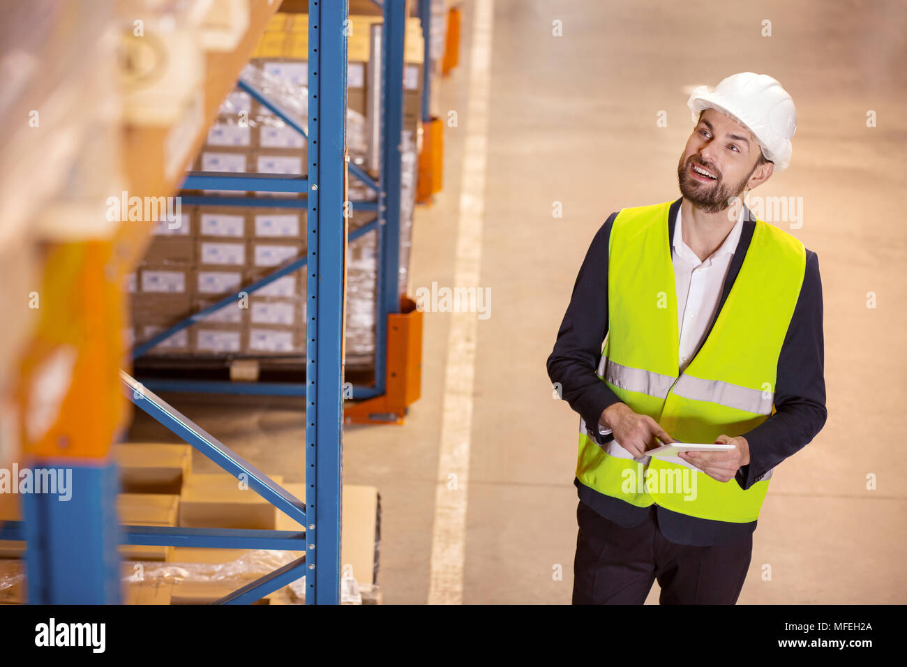 Cheerful smart man looking at the boxes Stock Photo - Alamy