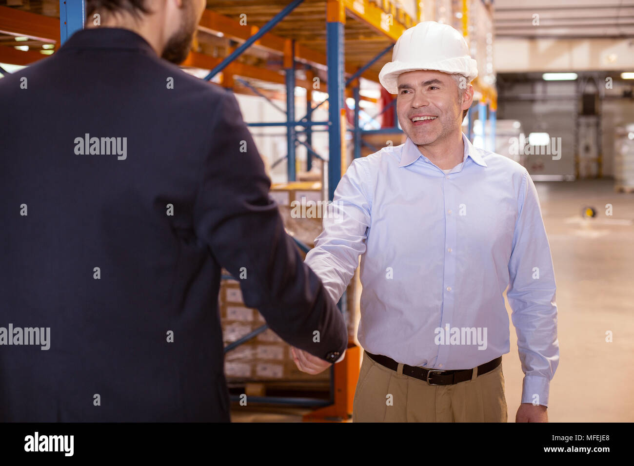 Joyful positive man greeting his boss Stock Photo - Alamy