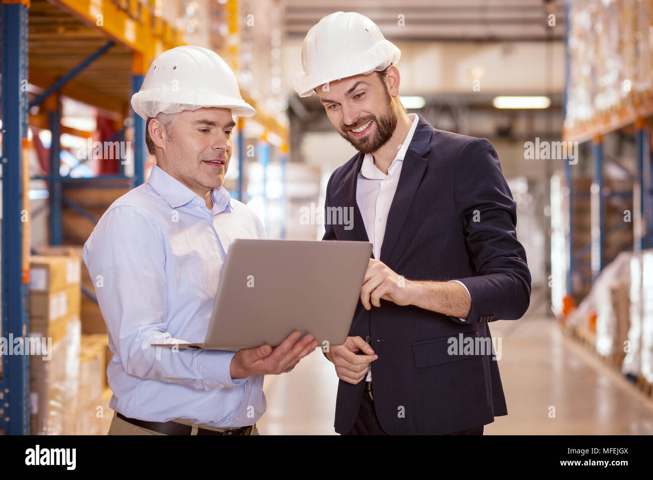 Delighted nice man pointing at the laptop screen Stock Photo - Alamy
